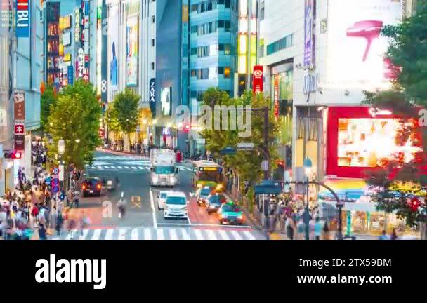 People cross the famous intersection in Shibuya, Tokyo, Japan one of ...