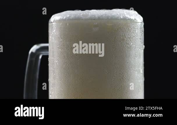 Beer foam flowing down glass walls, soft drink, pasteurized and ...