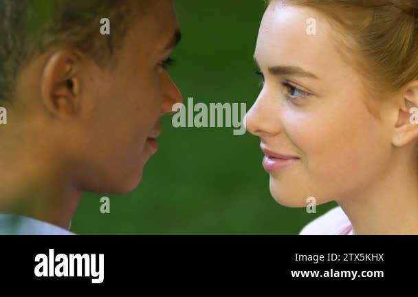 Beautiful biracial couple putting foreheads together, respect and trust ...