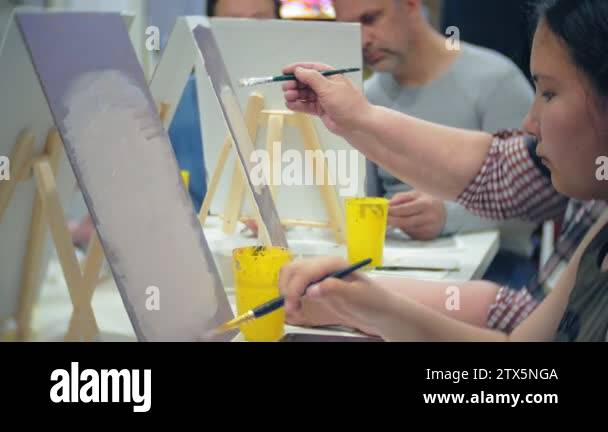 art school, creativity and people concept - group of students with ...