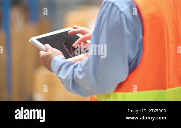 Quality inspector in small warehouse. Senior chinese male inspector ...