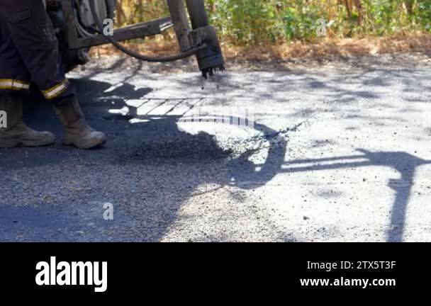 fast road surface repair process by asphalt, bitumen spraying. spray ...