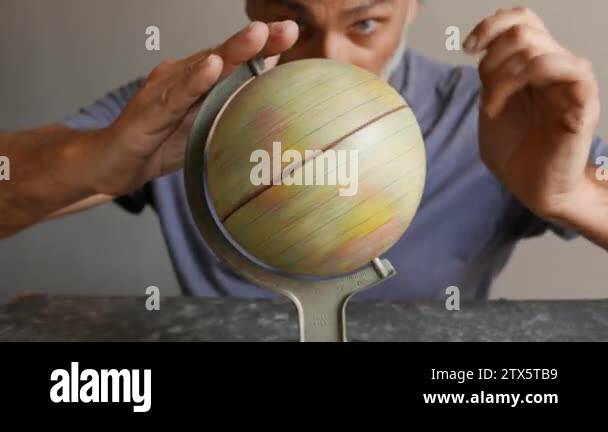 out of focus man behind vintage earth globe, psychology of World ...