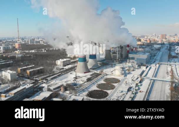 Smooth aerial shot around industrial factory chimney, dense fume comes ...