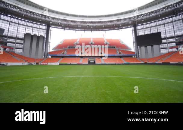 Outdoor stadium with football field and stands. Action. Inside view of ...