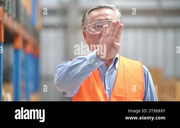 Senior man pointing at camera. Old asian man with safety glasses ...