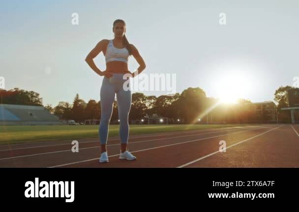 Beautiful Fitness Woman in Light Blue Athletic Top and Leggings is ...