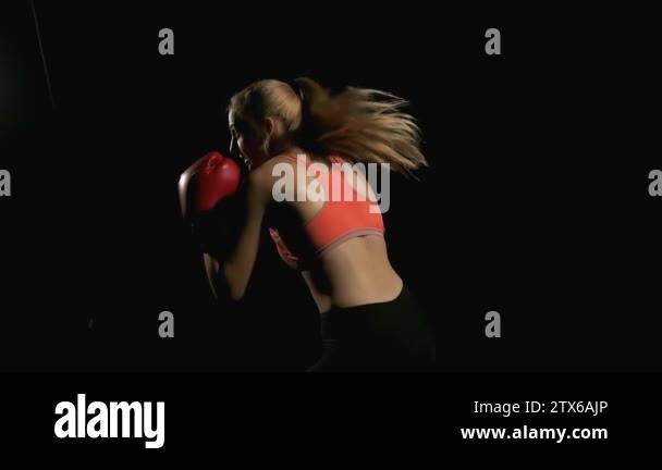 Young intense woman throwing punches. Punching air. White young ...