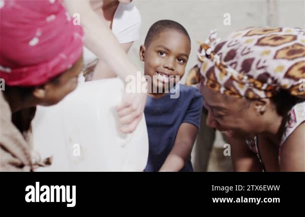 Stream of fresh water and the hands of people from a poor community ...
