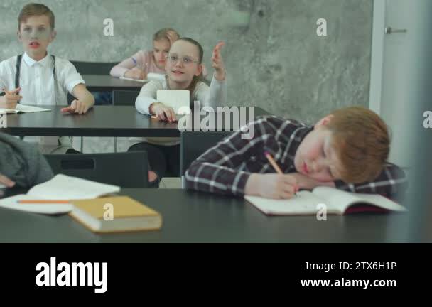 Primary school children working in the classroom with teacher Stock ...
