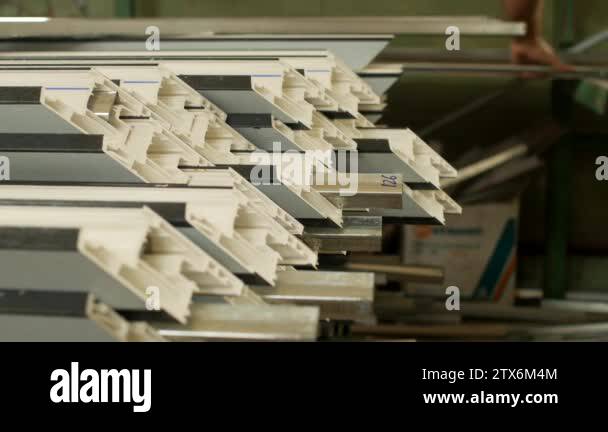 Manufacturing windows pvc, male worker inserts a metal profile into the ...