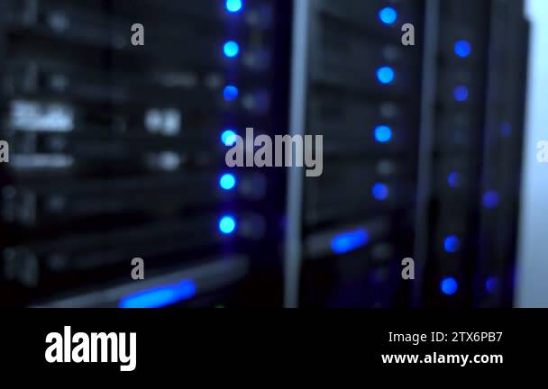 Data center, server room in a blurry background. Blinking blue led ...