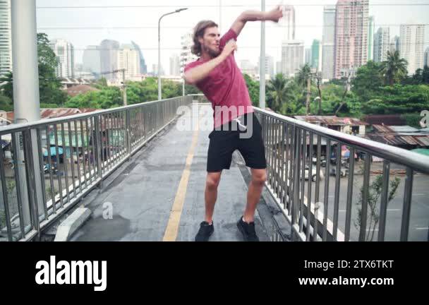 Man dancing on the urban street. Fit white man dancing in the middle of ...