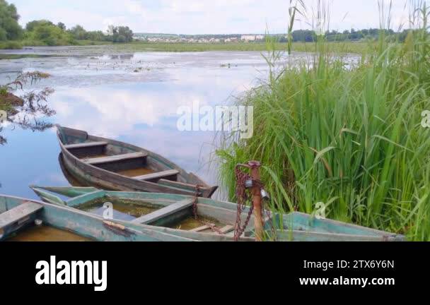 beautiful scenery landscape with pond, wooden boats for fishing on the ...