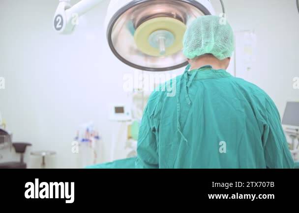 Surgeon at work portrait. Senior chinese surgeon smiling in operating ...