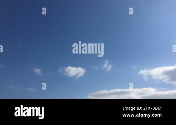 Cloudy sky. White clouds disappear in the hot sun on blue sky. Time ...