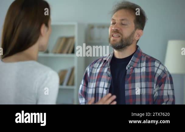 Woman giving slap to husband in family quarrel, uncontrolled aggression ...