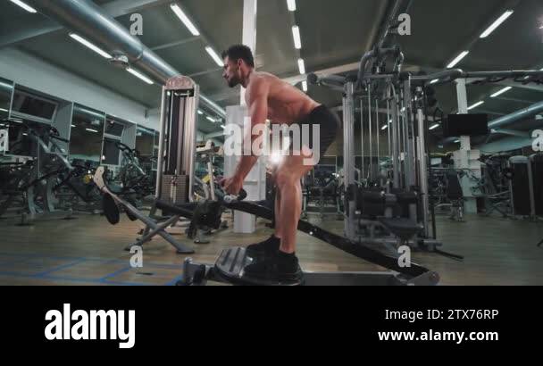 Large gym class good looking man exercises hard to make more muscle ...