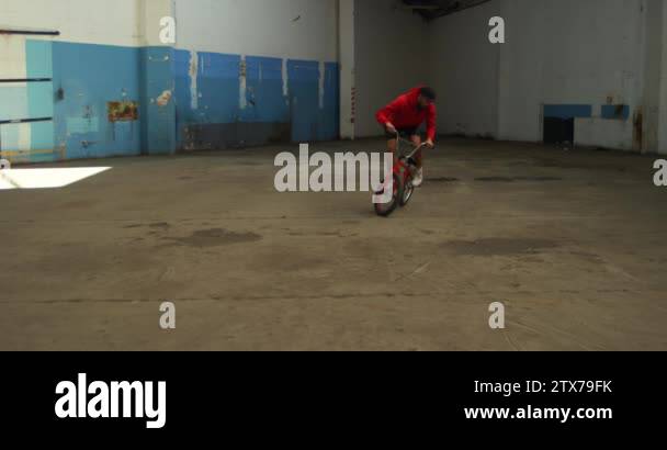 Side view of a young Caucasian man jumping, turning and balancing on ...