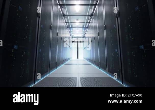 Camera slowly moving along the narrow corridor in data center with ...