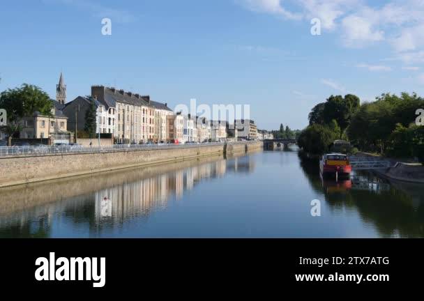 Buildings are reflected on the Sarthe River in the city of Le Mans in ...