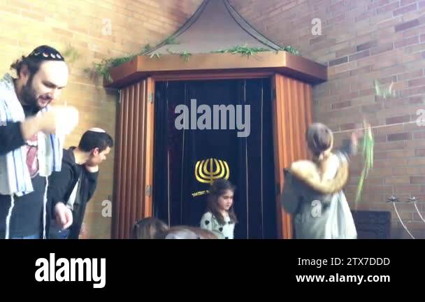 Jewish people preform the ritual of beating the willow in synagogue on ...