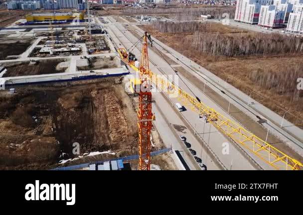 Around the cockpit of a tower crane with a panorama of new houses ...