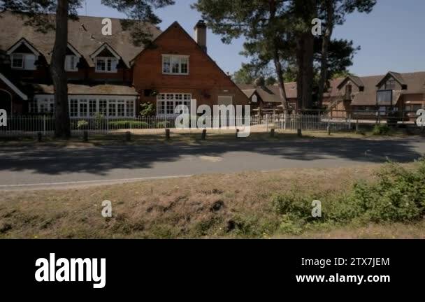 Pan from Beaulieu Hotel past Drift Inn to grazing New Forest pony in ...