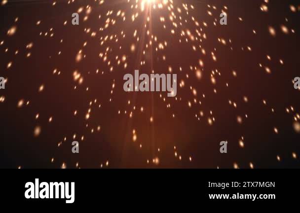 Fireworks sparks falling from top center against maroon background ...