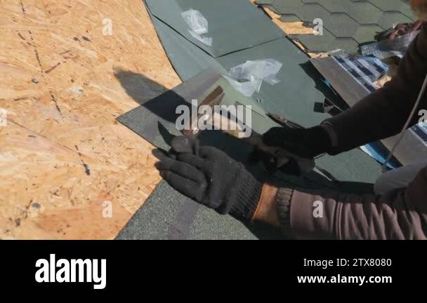 soft roof of shingles. Repair of the roof of a residential house ...