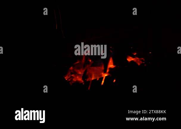 Sparks from a fire scatter on a black background. Sparks from a ...