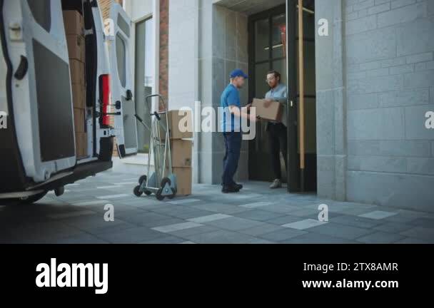 Delivery Man Takes Postal Package from a Customer who Signs Electronic ...
