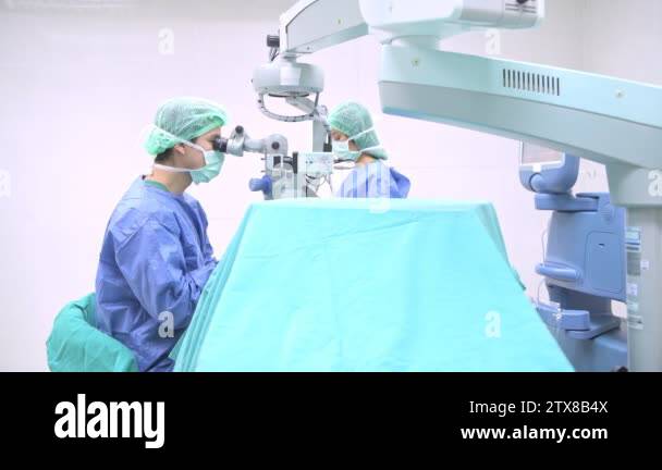 Eye surgeon at work. Young Caucasian male surgeon with his beautiful ...