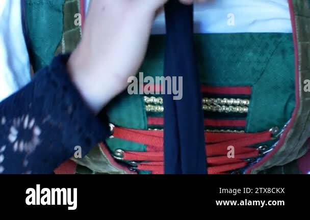 girl dresses a complex Tyrolean dress, typical of the traditional ...