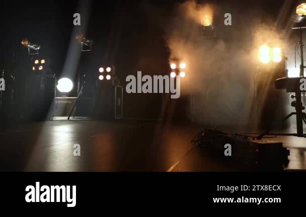 Close-up video of a concert stage and lighting fixtures on it. Smoke ...