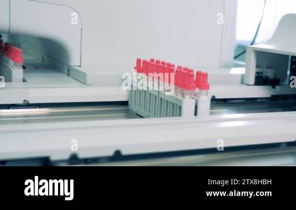 Test tubes are getting moved through the parts of the scanning machine ...