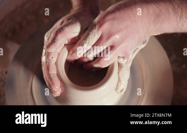 Traditional pottery making, man teacher shows the basics of pottery in ...