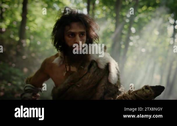 Portrait of Primeval Caveman Wearing Animal Skin and Fur Hunting with a ...