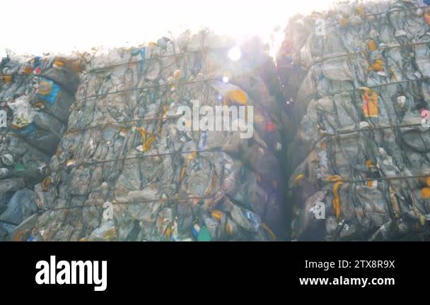 Blocks of junk plastic bottles storaged outdoors. Waste recycling ...