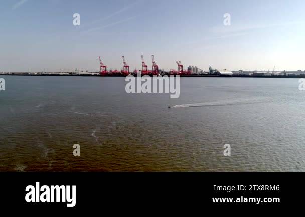 Drone descends in front of Liverpool docks as a speedboat approaches ...