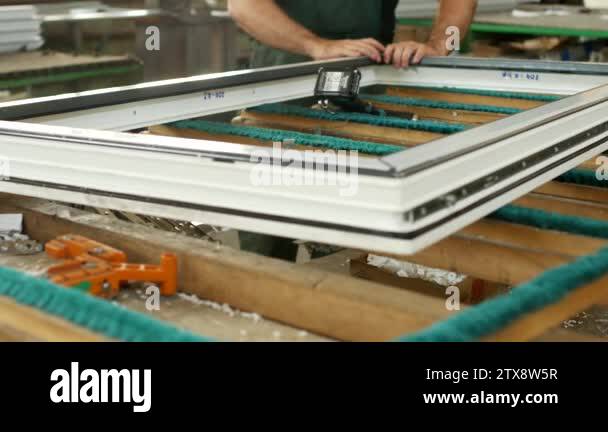 Production and manufacturing of pvc windows, the male worker assembles ...