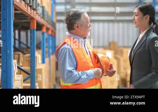 Quality inspector in small warehouse. Senior chinese male inspector ...