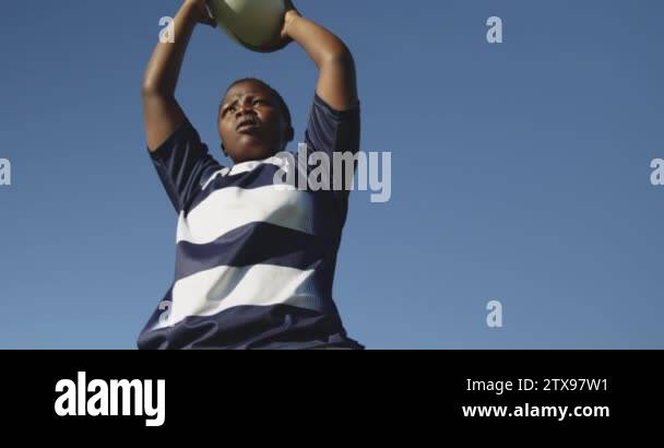 Front view low angle of a young adult mixed race female rugby player ...