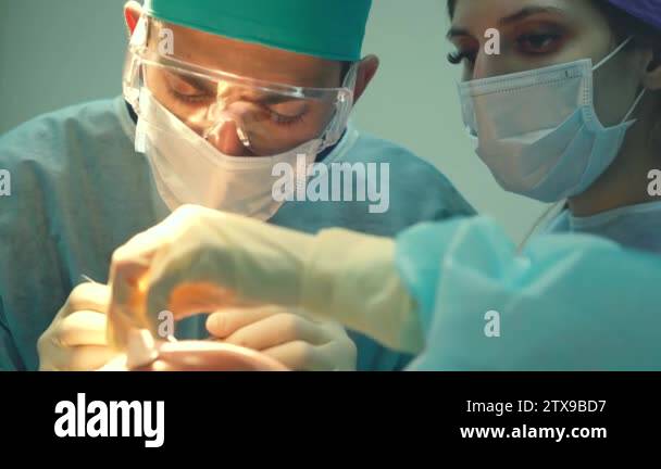 Baldness treatment. Hair transplant. Surgeons in the operating room ...