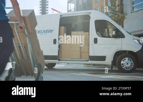 Delivery Man Uses Hand Truck Trolley Full of Cardboard Boxes and ...