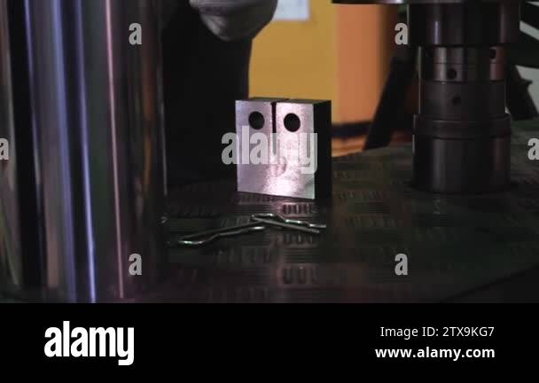 Metal sample is tested for compressive strength. Footage. Close-up of ...