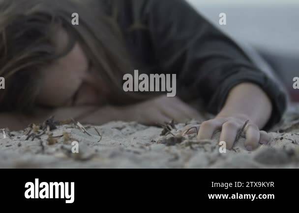 Female shipwreck victim regaining consciousness on ocean coast and ...