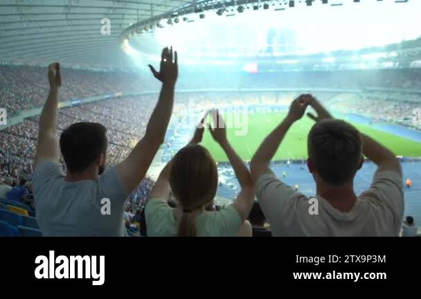 Football fans clapping hands, chanting, supporting national team at ...