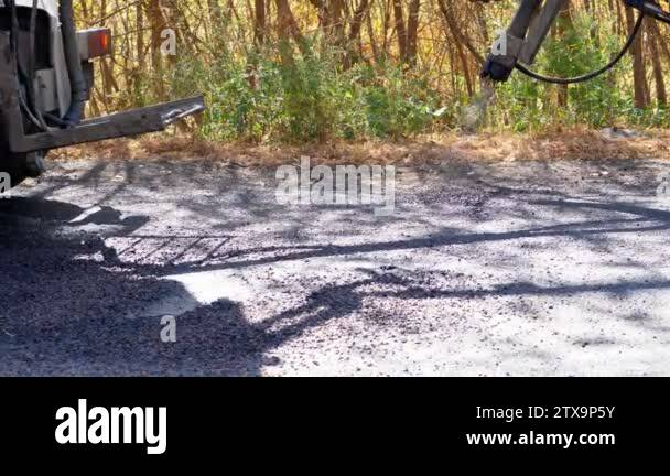 fast road surface repair process by asphalt, bitumen spraying. spray ...