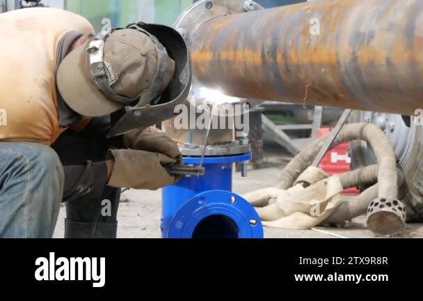 Welding pipeline. Welder worker welding pipe by electrode. Electrodes ...